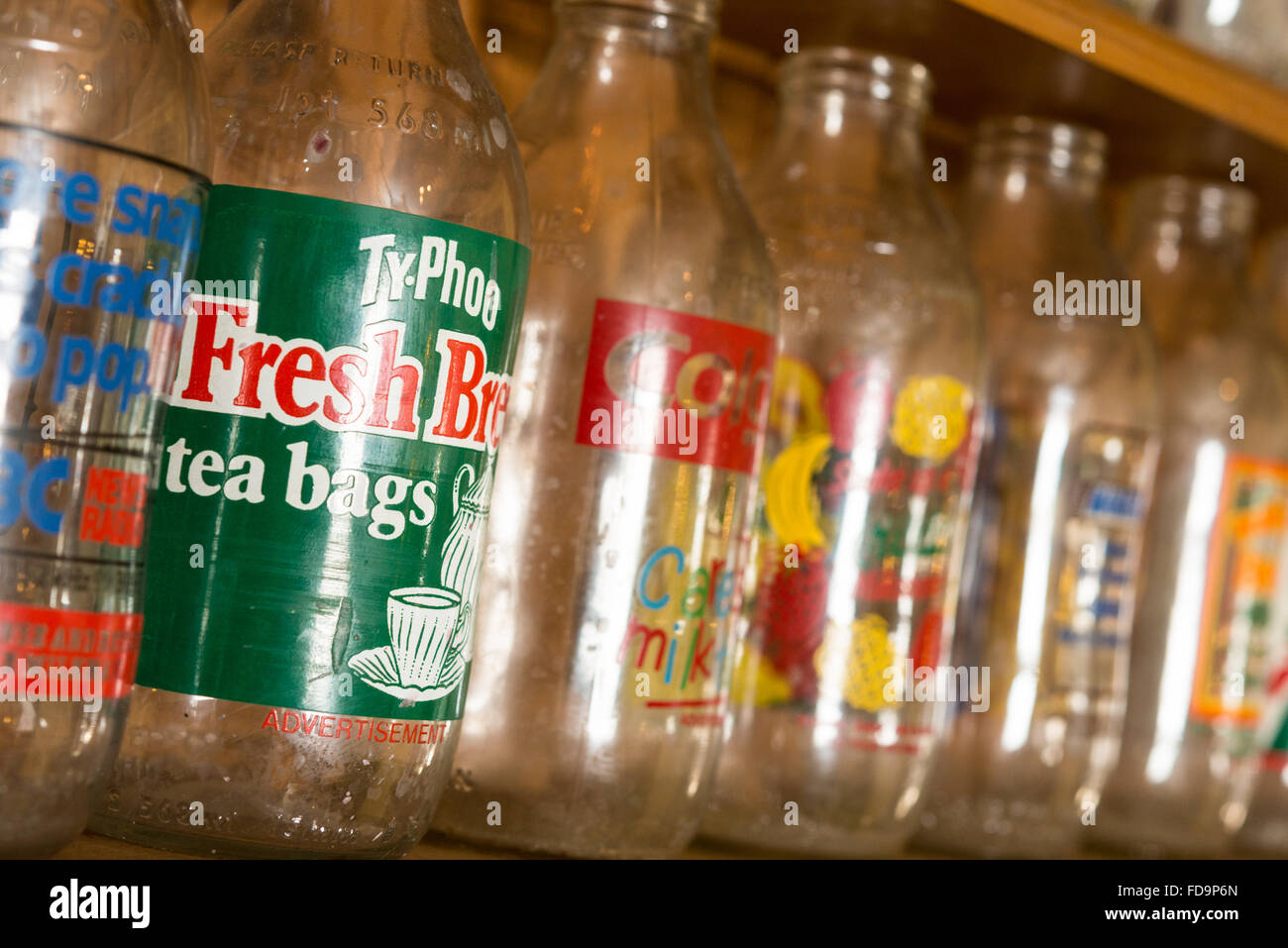 An old or vintage milk bottle collection displayed on a shelf Stock ...