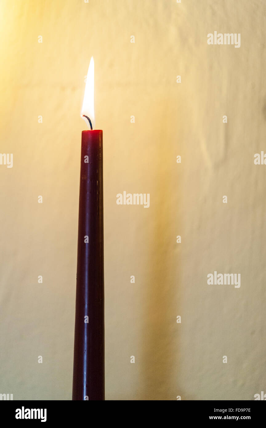 A candle alight next to a wall Stock Photo - Alamy