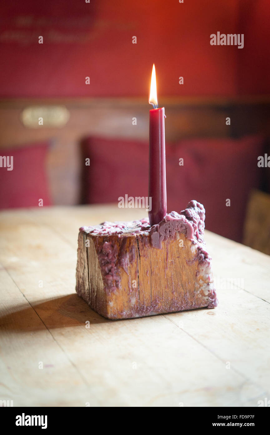 A candle in the interior of a building on a table Stock Photo - Alamy