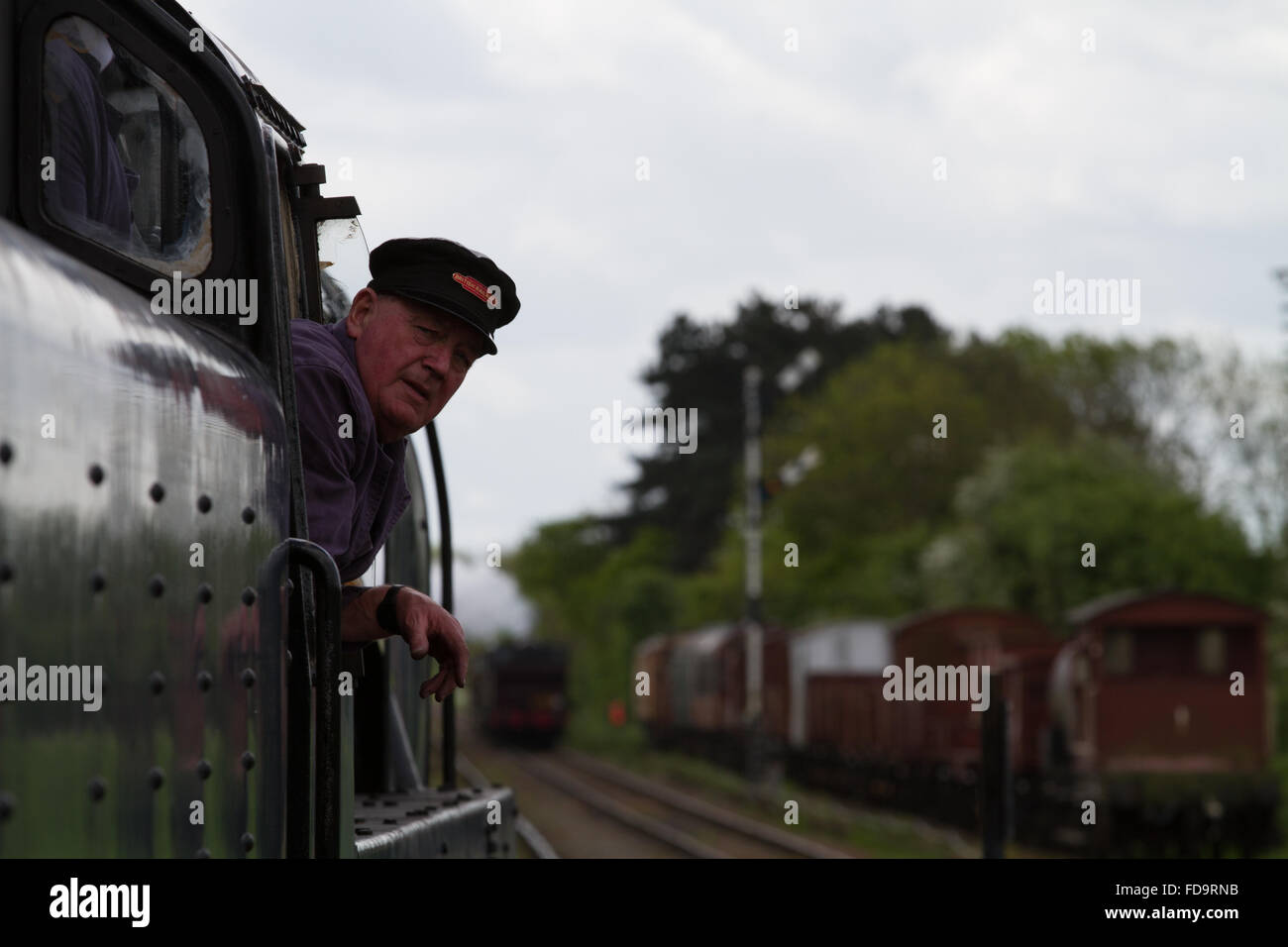 Steam train driver waits for the green flag signal on the Great Central ...