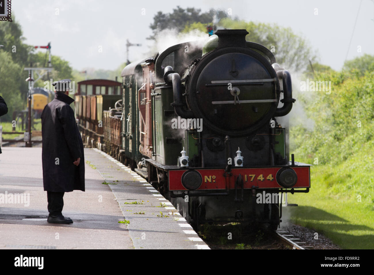 The stationmaster watches LNER tank 1744 haul a short freight train on ...
