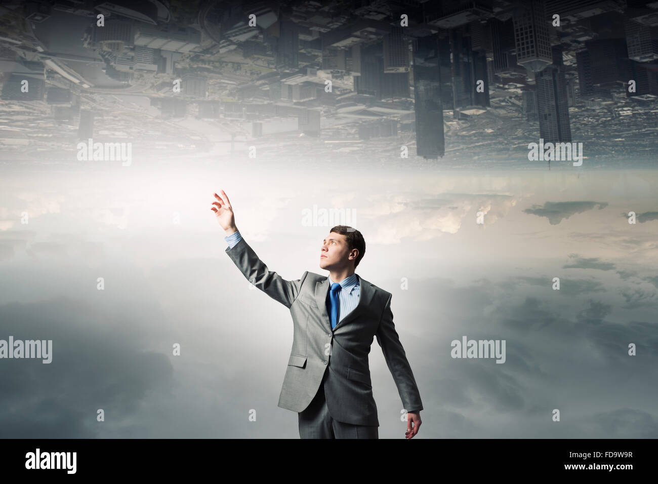 Businessman reaching his arm up to touch something Stock Photo - Alamy