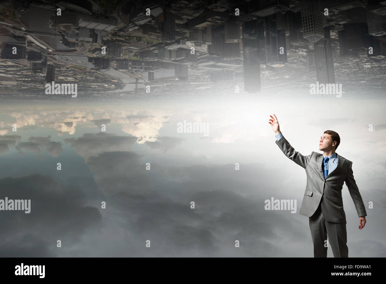 Businessman reaching his arm up to touch something Stock Photo - Alamy