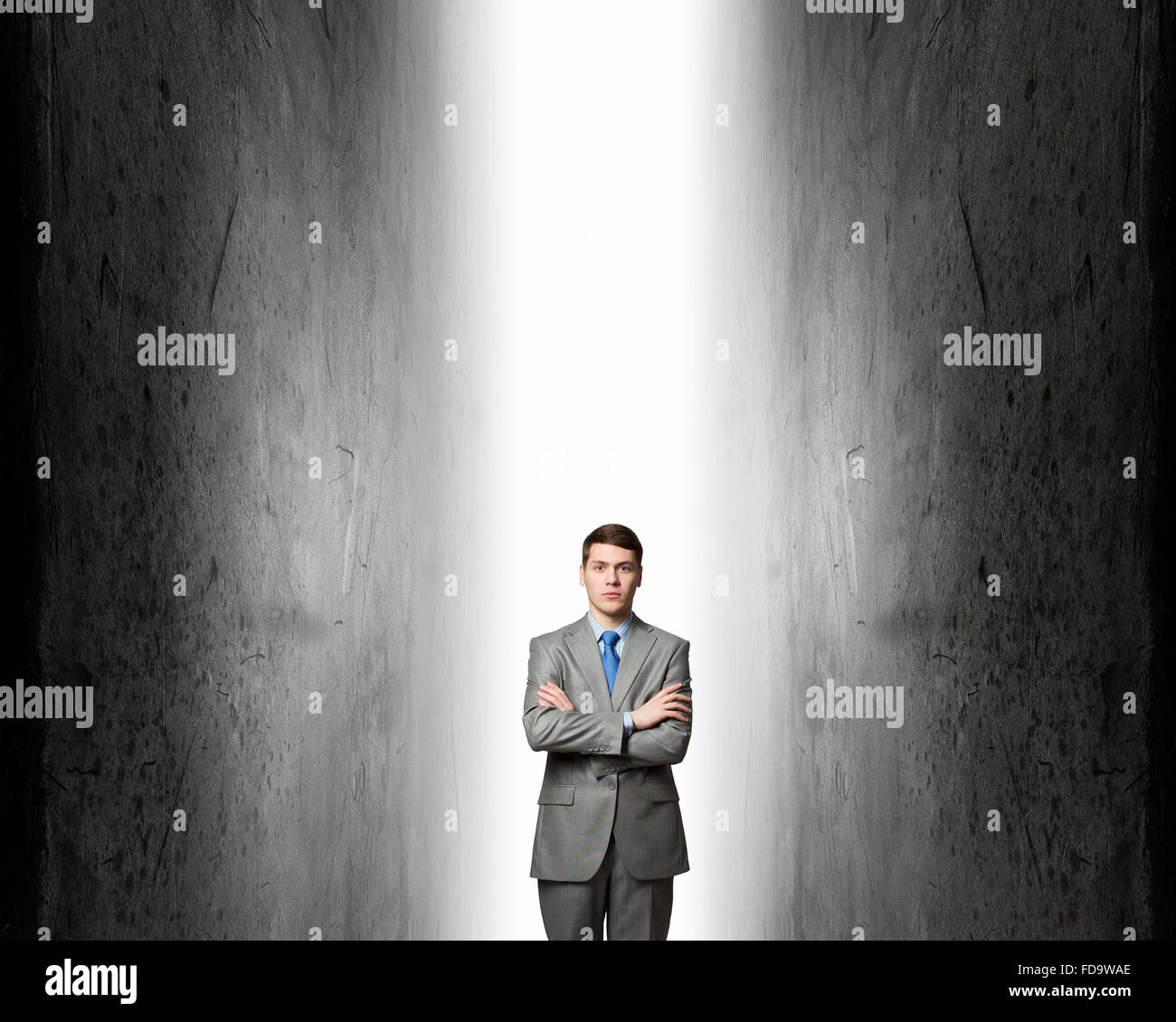 Young confident businessman with hands crossed on chest between two ...