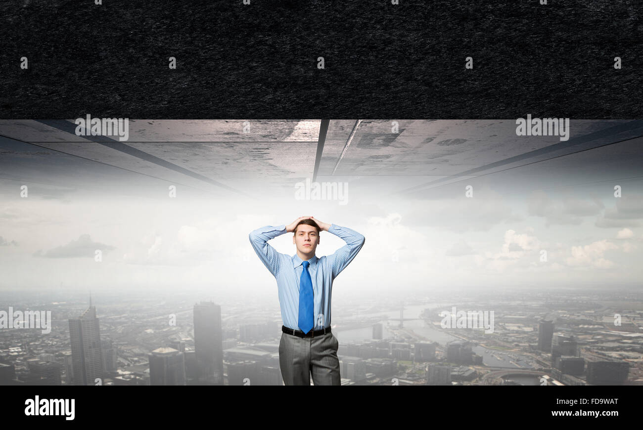 Young confident businessman with hands on head under pressure Stock ...