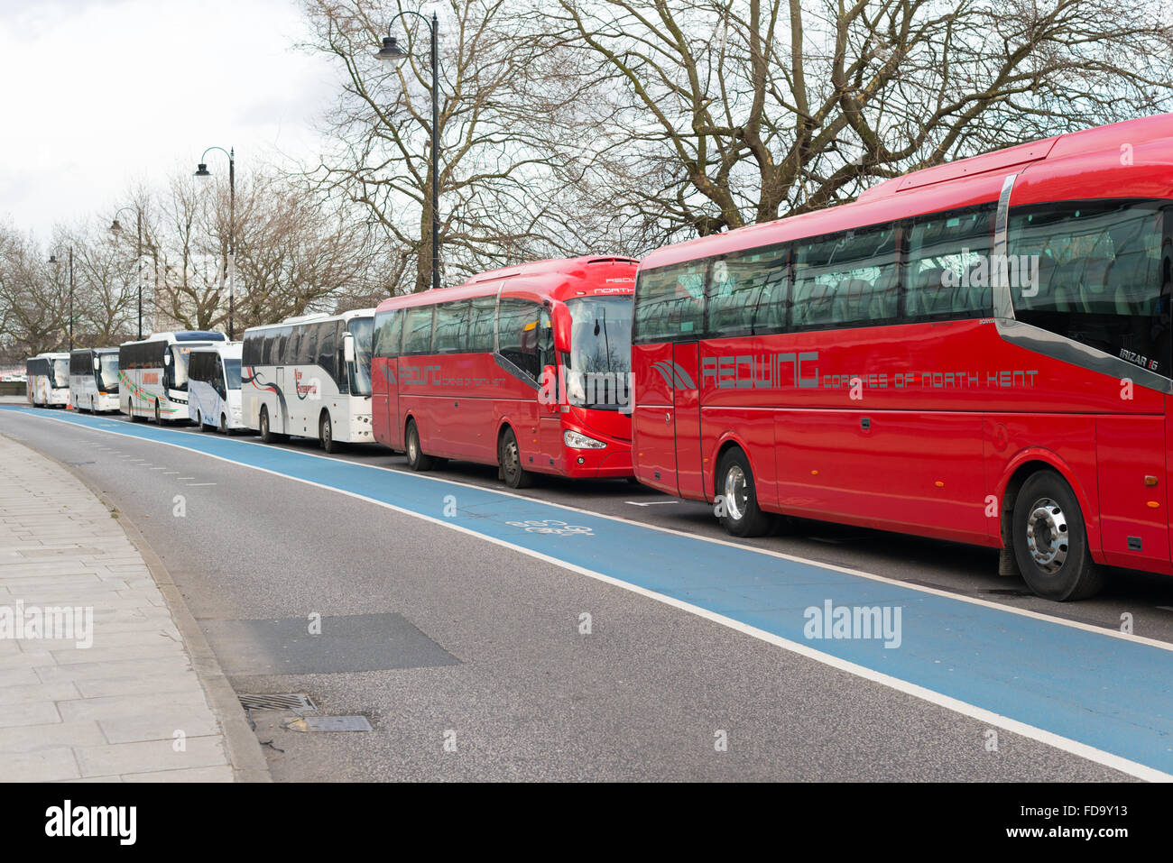 Coaches or buses parked on the road at Millbank London UK Stock Photo ...