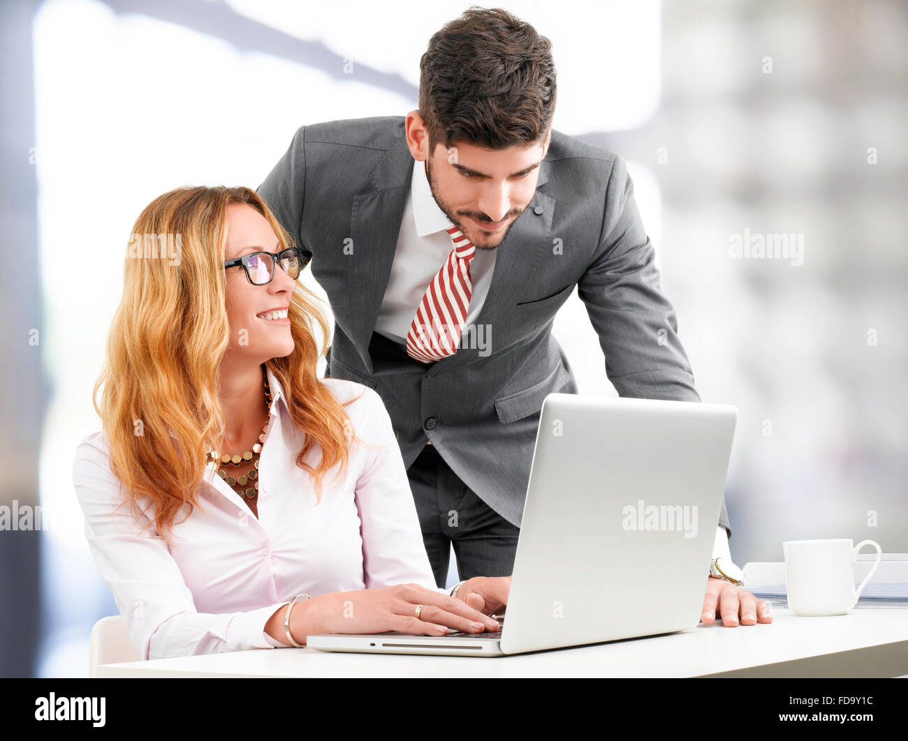 Portrait of efficiency sales team working on laptop, while sitting at ...