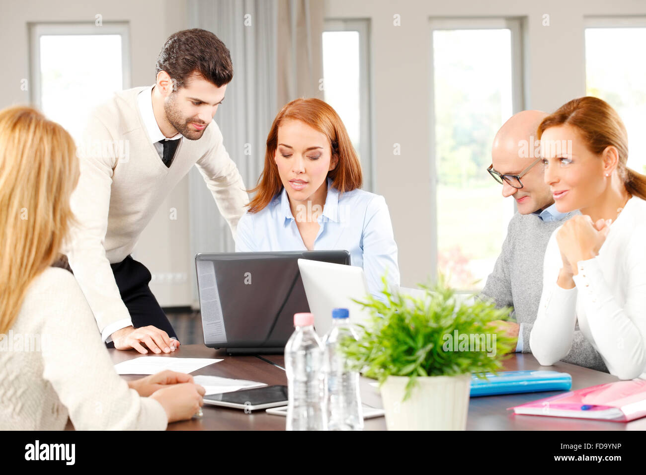 Business colleagues working on laptop while they sitting at meeting ...