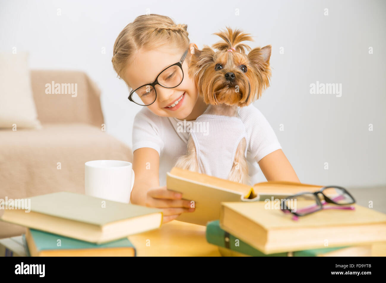 Little girl is reading with her dog Stock Photo - Alamy
