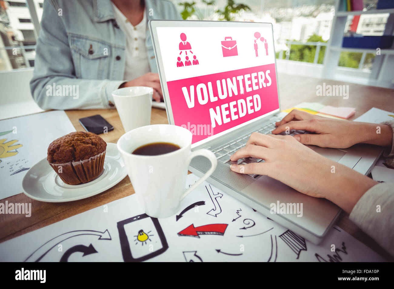 Composite image of yellow volunteers needed Stock Photo - Alamy