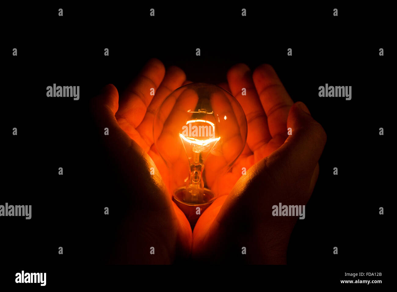 Black hand holding light bulb hi-res stock photography and images - Alamy