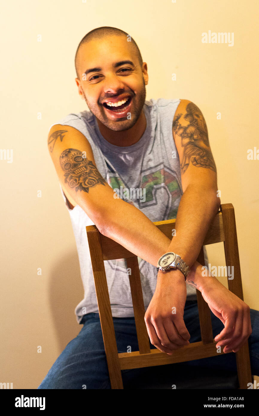 Comedian Sam Smedley laughing and sitting on a chair Stock Photo - Alamy