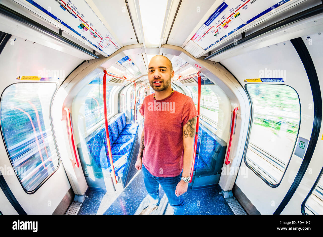 London comedian Sam Smedley standing on a tube train Stock Photo - Alamy