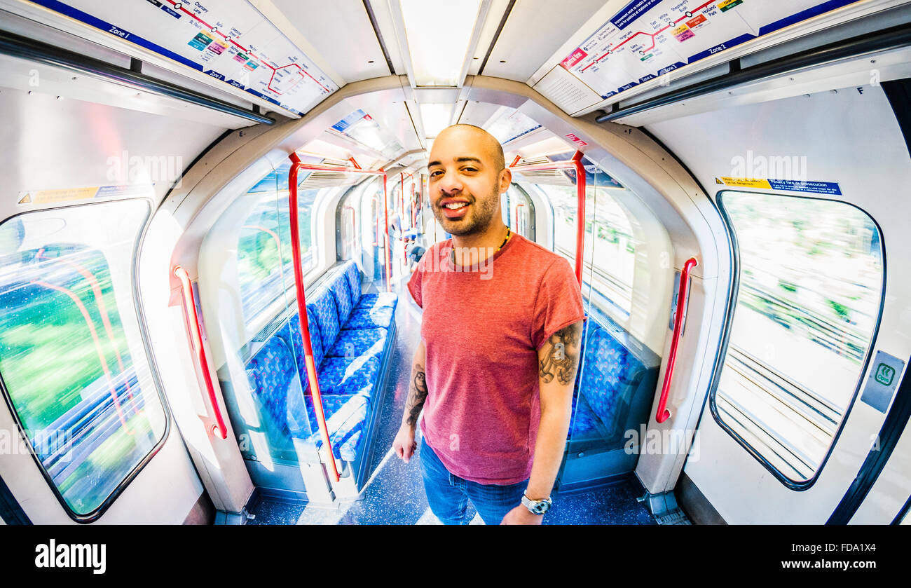 London comedian Sam Smedley standing on a tube train Stock Photo - Alamy