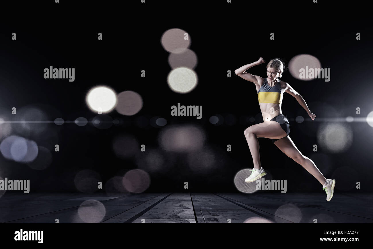 Young woman athlete running fast on dark background Stock Photo - Alamy
