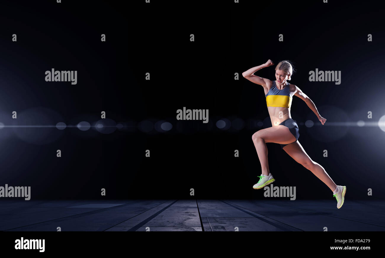 Young woman athlete running fast on dark background Stock Photo - Alamy
