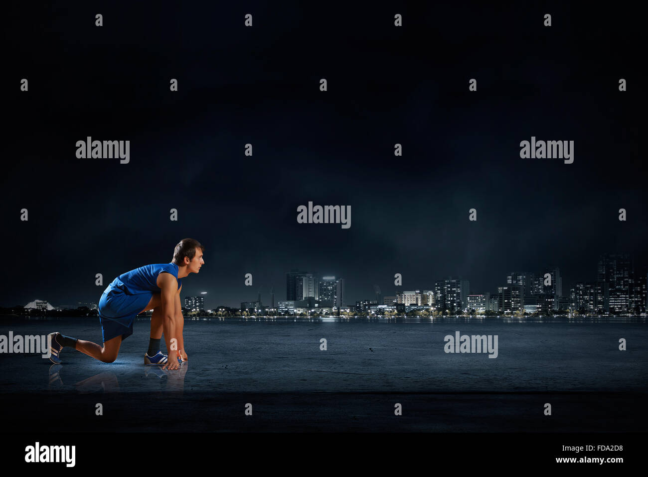 Young man athlete standing in start pose Stock Photo - Alamy