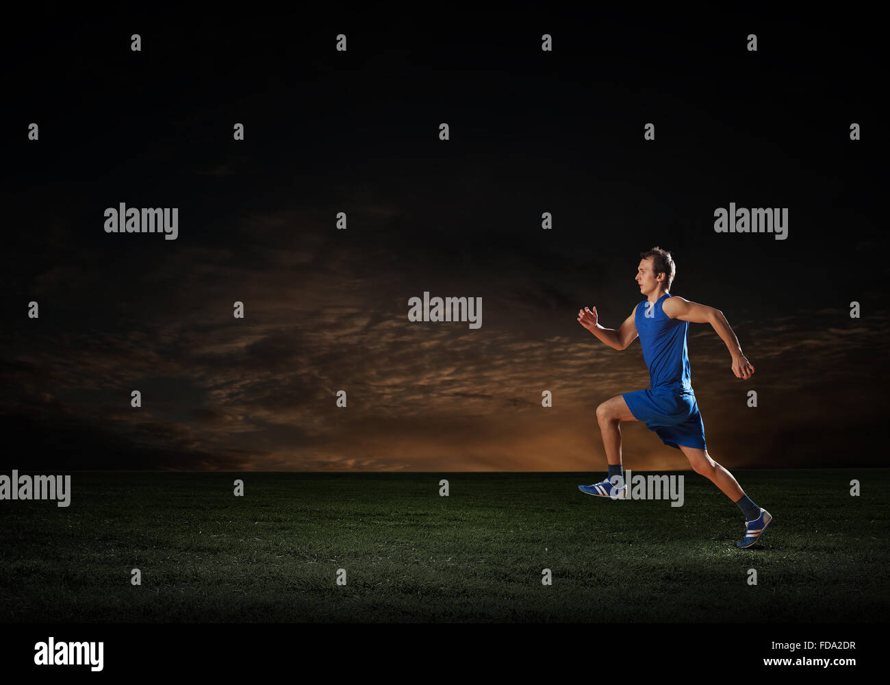 Young running man athlete in blue wear Stock Photo - Alamy