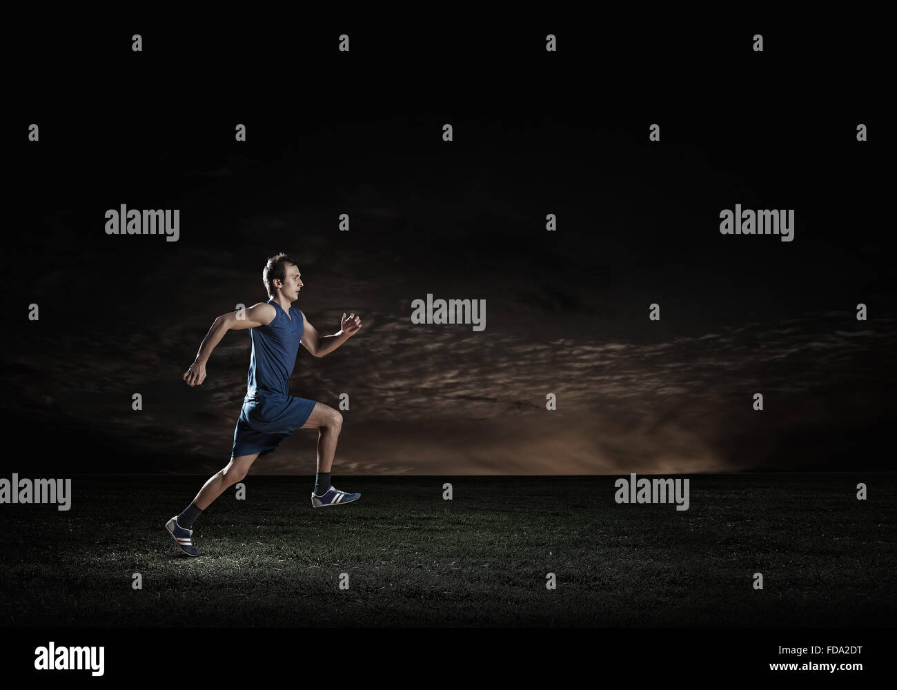 Young running man athlete in blue wear Stock Photo - Alamy