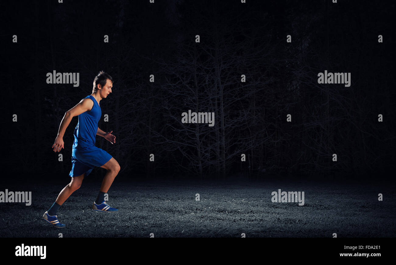 Young running man athlete in blue wear Stock Photo - Alamy