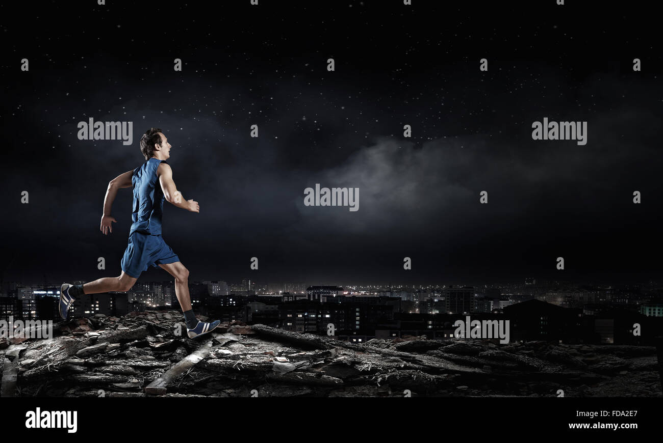 Young man athlete in blue wear running outdoor Stock Photo - Alamy