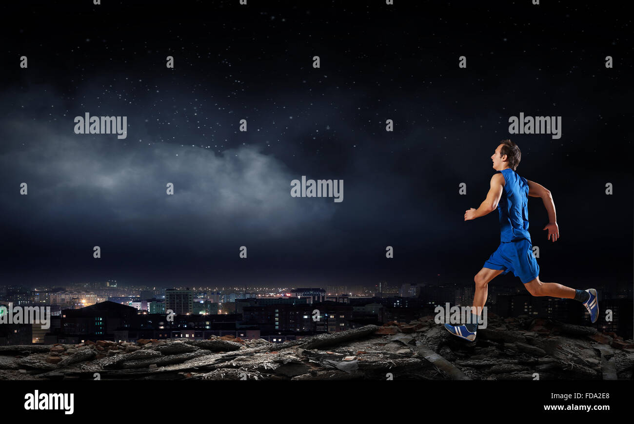 Young man athlete in blue wear running outdoor Stock Photo - Alamy