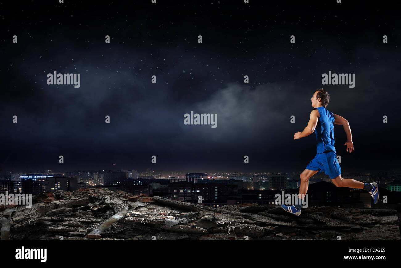 Young man athlete in blue wear running outdoor Stock Photo - Alamy