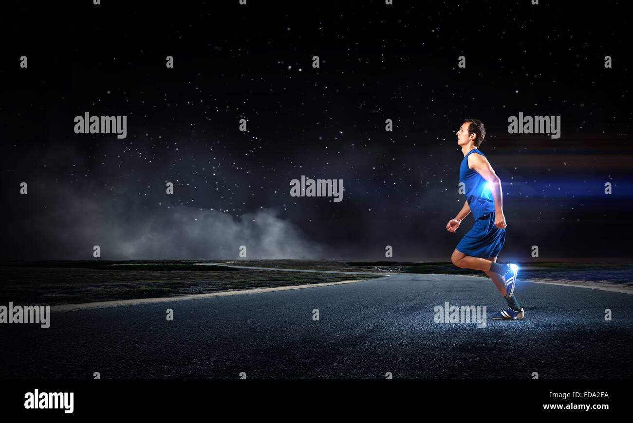 Young running man athlete in blue wear Stock Photo - Alamy