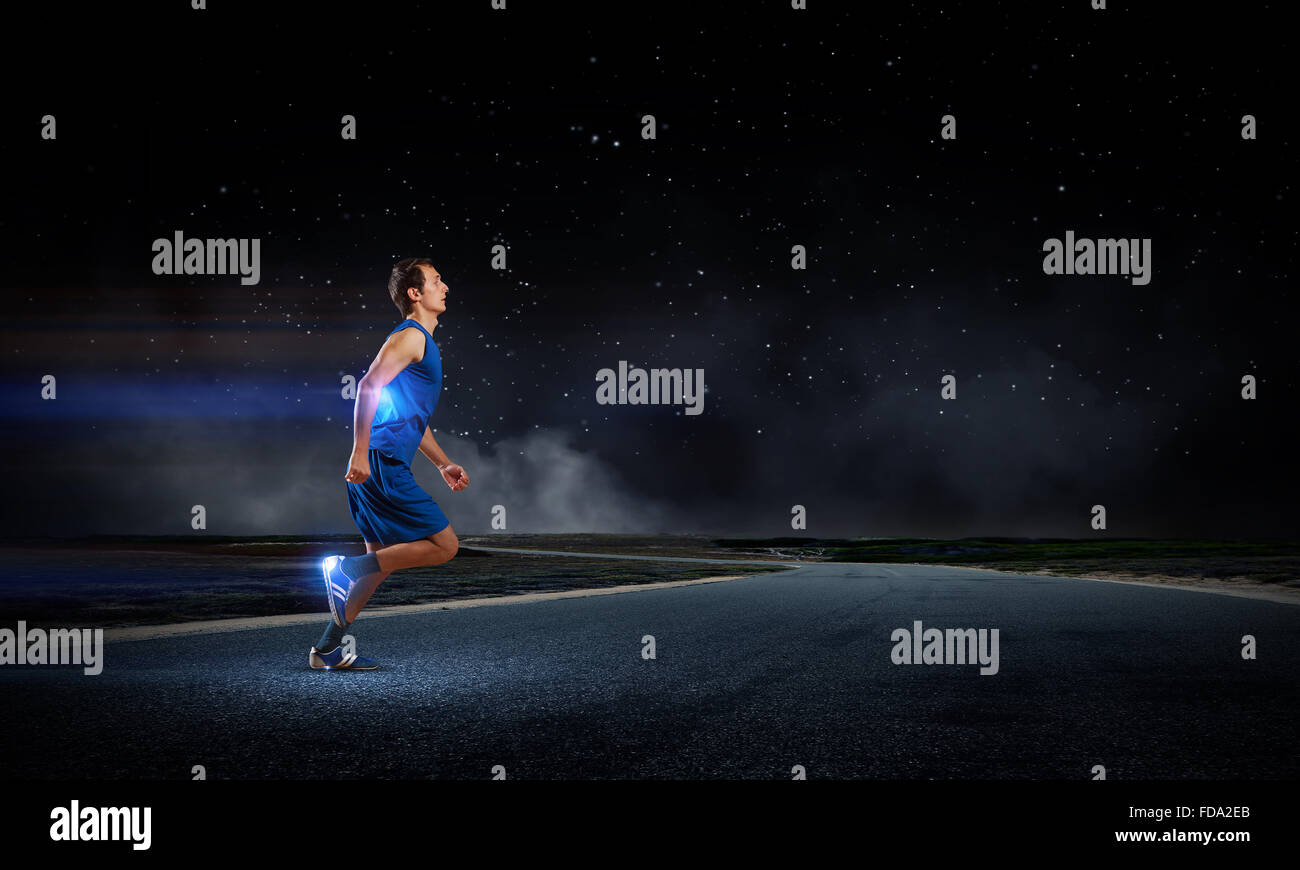 Young running man athlete in blue wear Stock Photo - Alamy