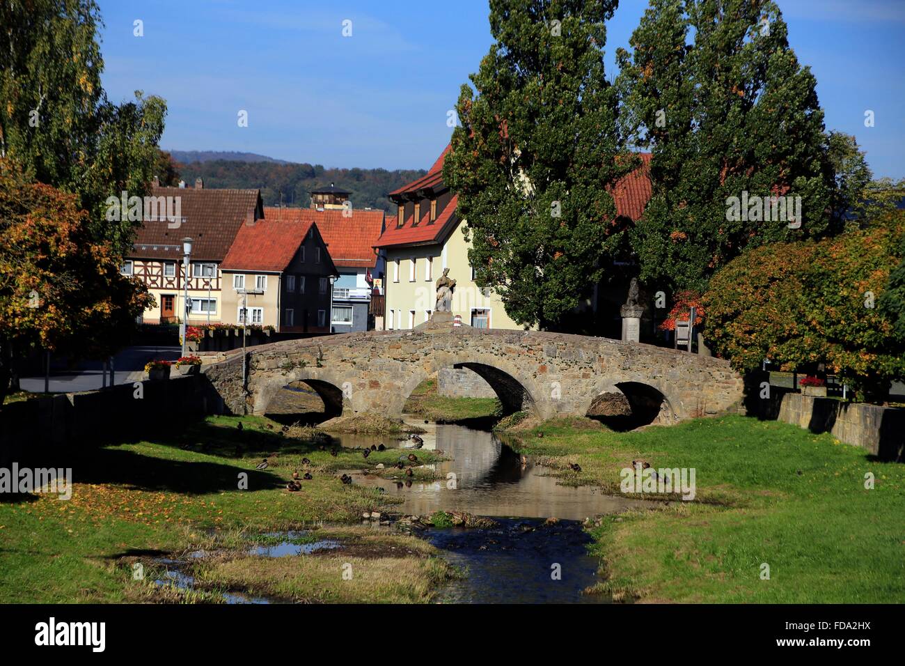 Flower arrangement on the seawall of the creek "Streu" in Nordheim vor ...
