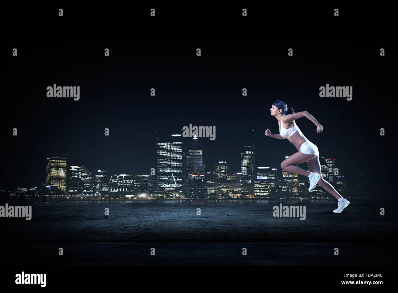 Young woman athlete running fast on dark background Stock Photo - Alamy