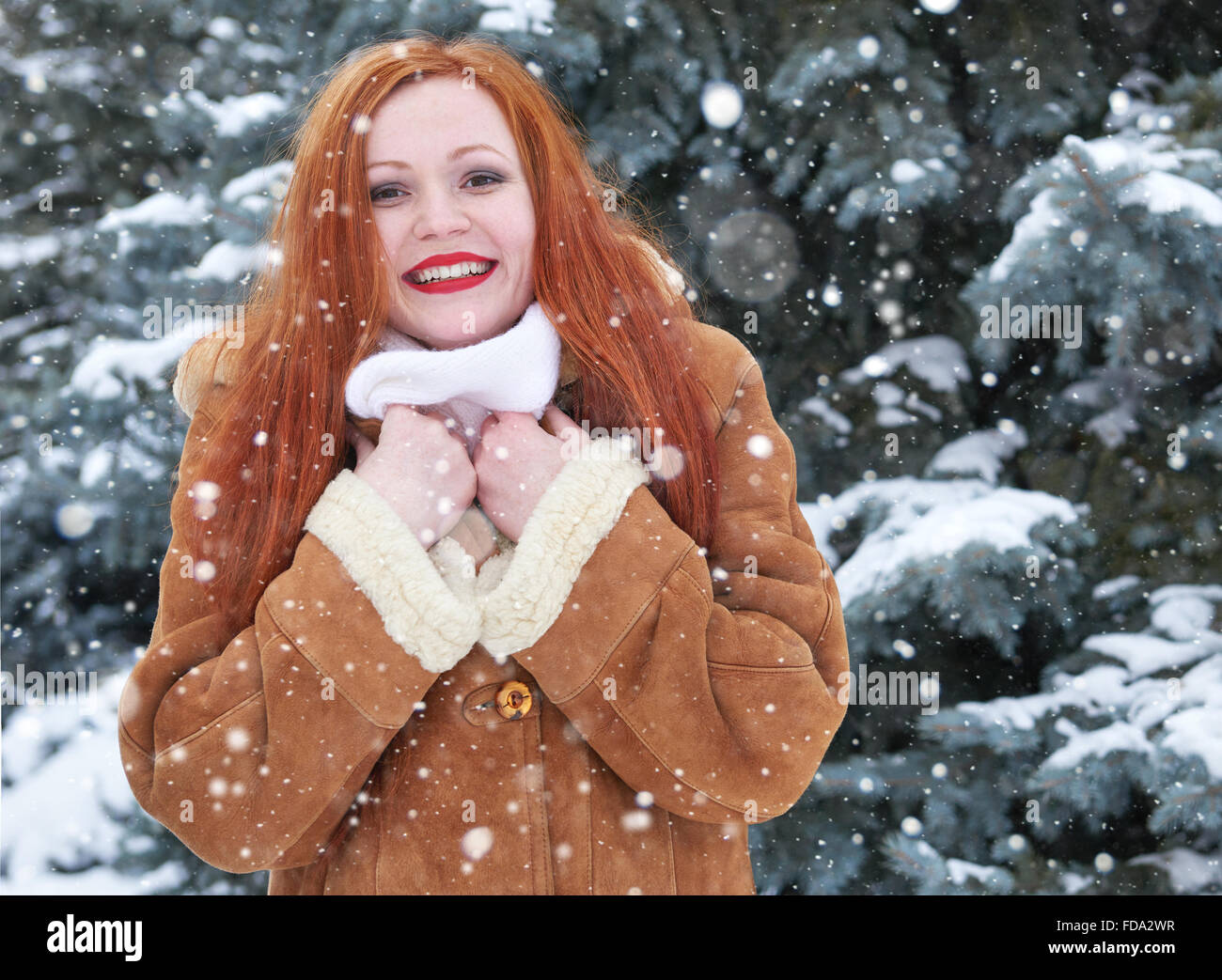 Winter redhead woman outdoor portrait, snowy fir trees background Stock ...