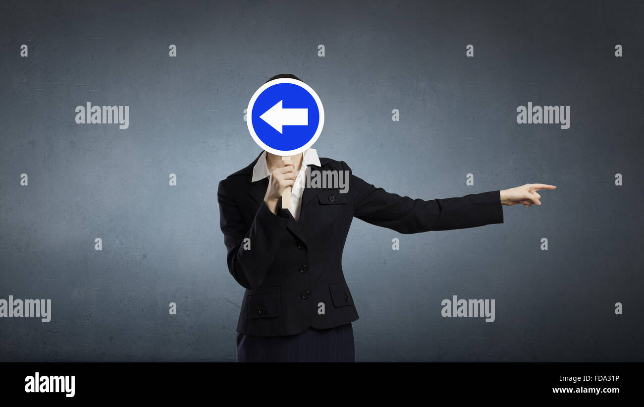 Unrecognizable businesswoman hiding her face behind mask and showing ...