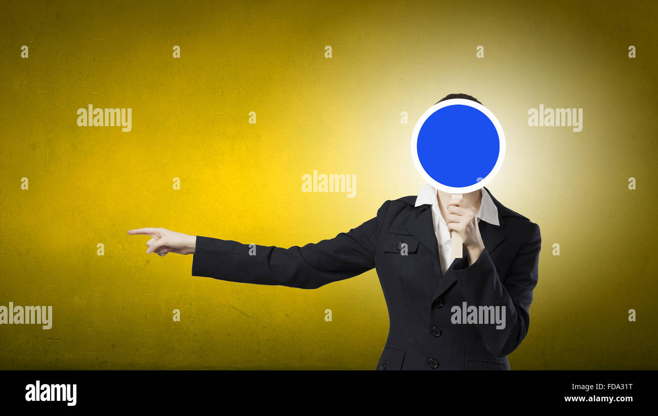 Unrecognizable businesswoman hiding her face behind mask and showing ...