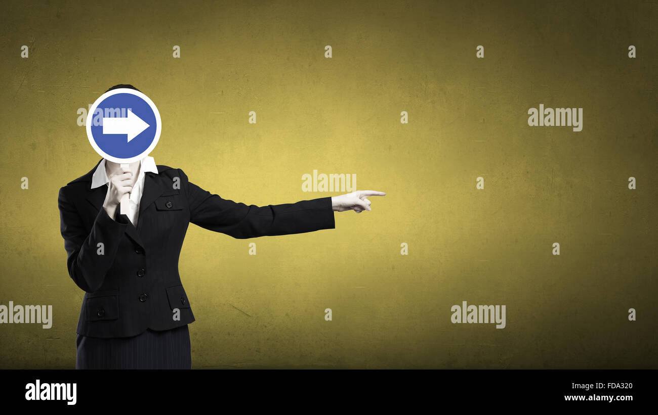 Unrecognizable businesswoman hiding her face behind mask and showing ...