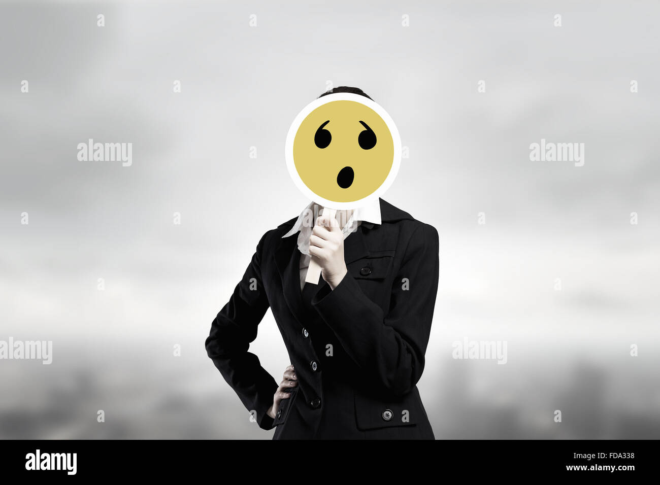 Unrecognizable businesswoman hiding her face behind sad mask Stock ...