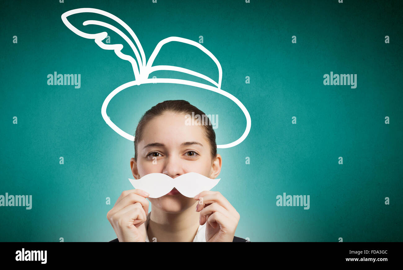 Happy cute girl trying male paper mustache Stock Photo - Alamy