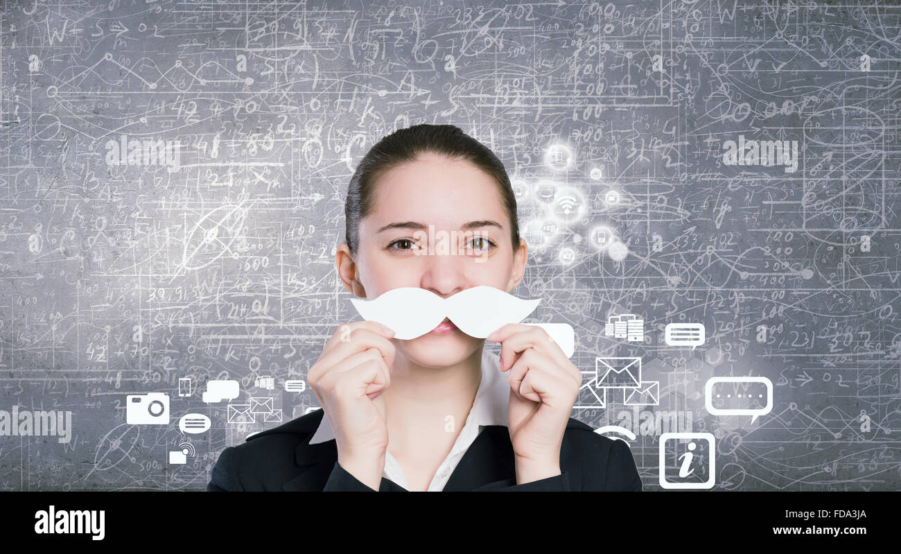 Happy cute girl trying male paper mustache Stock Photo - Alamy