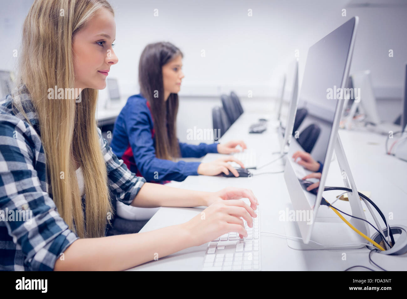 Smiling student working on computer Stock Photo - Alamy