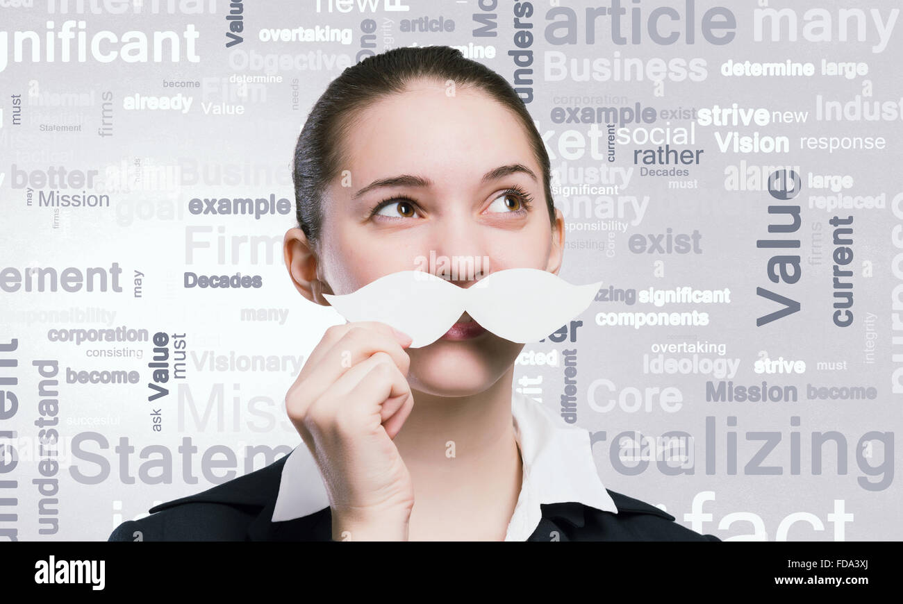 Happy cute girl trying male paper mustache Stock Photo - Alamy