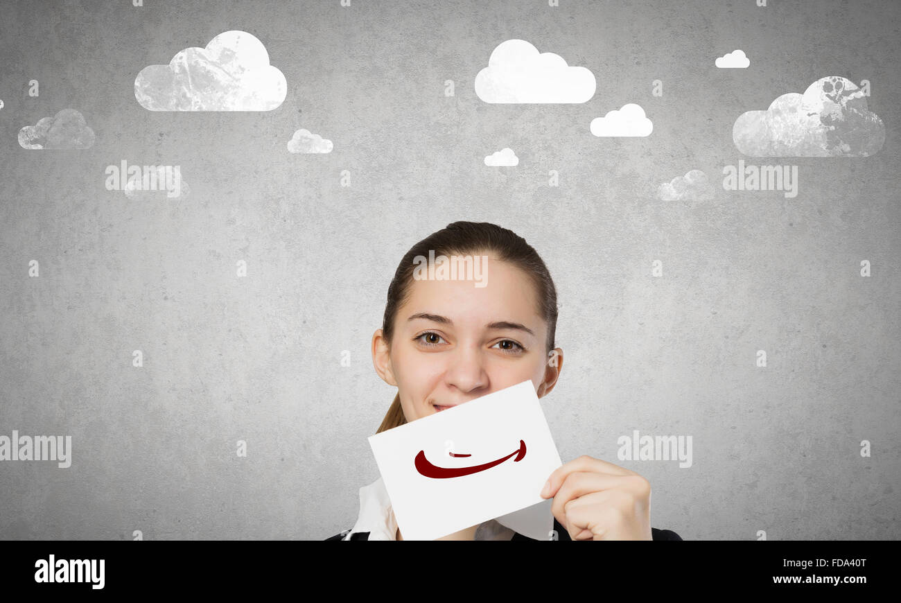 Young businesswoman holding paper with unhappy sad smiley Stock Photo ...