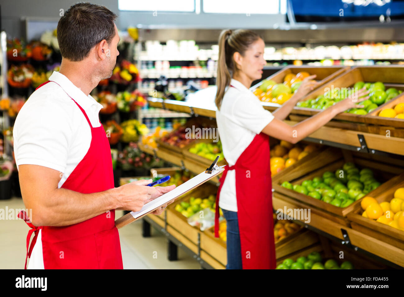 Grocery store staff with clipboard Stock Photo - Alamy