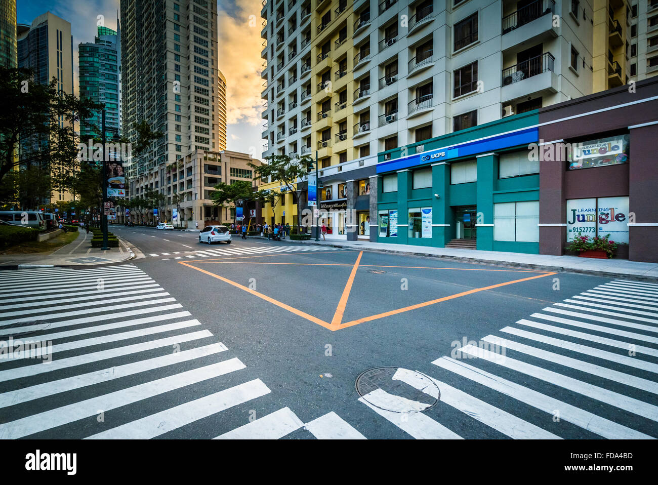 Modern skyscrapers and intersection in Bonifacio Global City at sunset ...