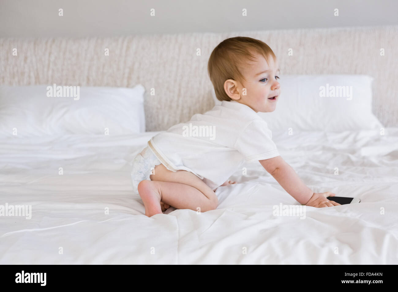 Cute baby using smartphone Stock Photo - Alamy