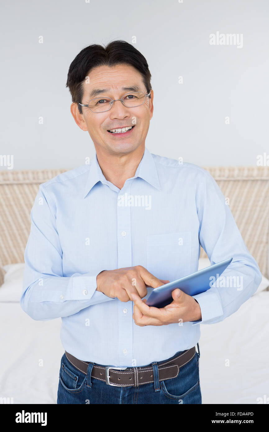 Smiling man using tablet Stock Photo - Alamy