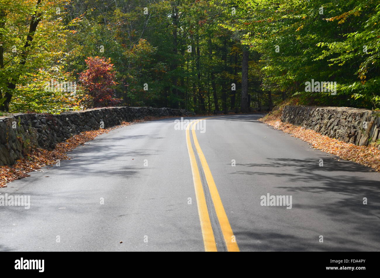 Country road with stone walls Stock Photo - Alamy