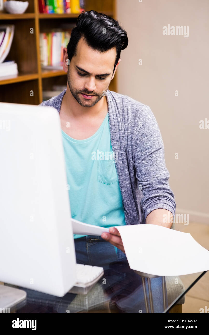 Serious creative man reading documents hi-res stock photography and ...