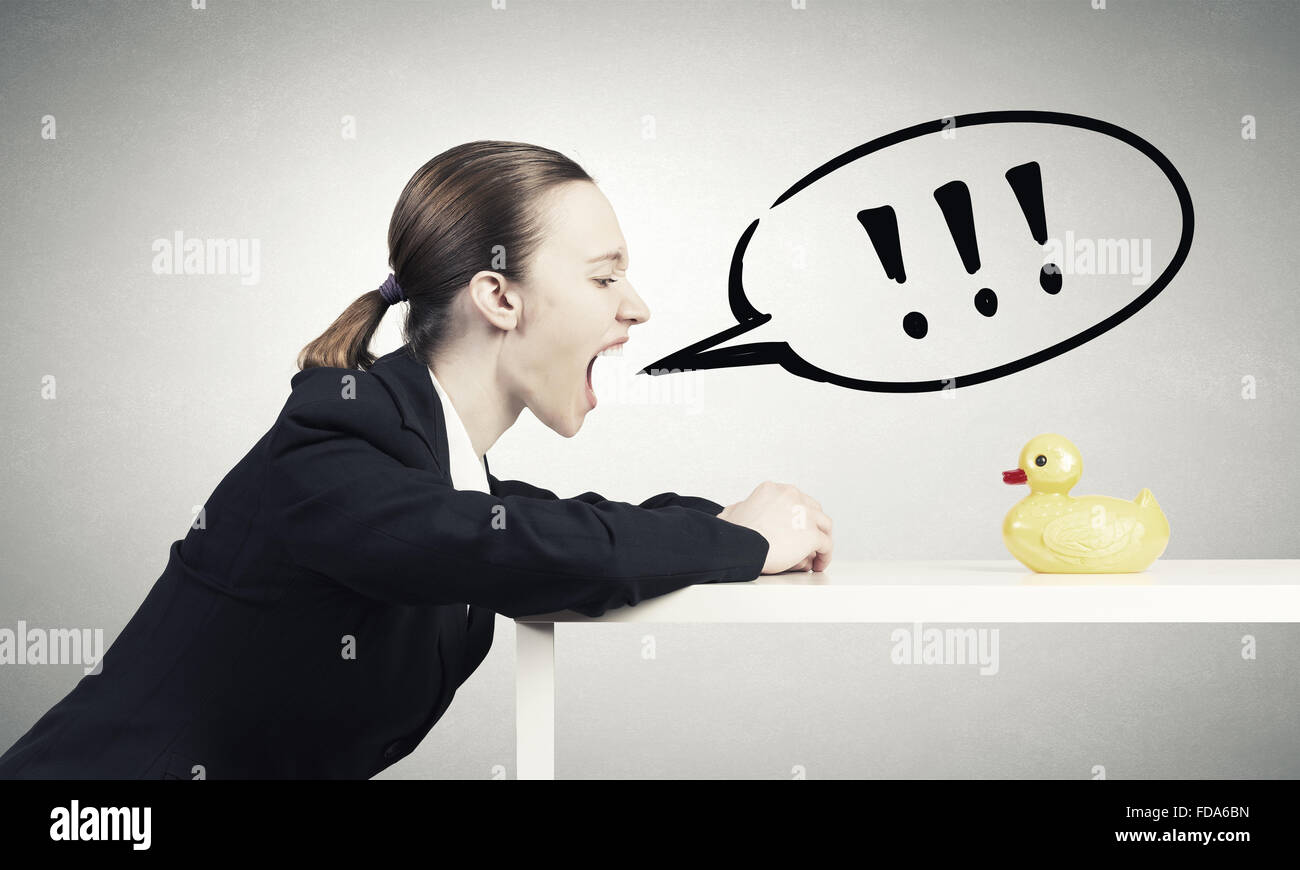Young businesswoman screaming on yellow rubber duck toy Stock Photo - Alamy