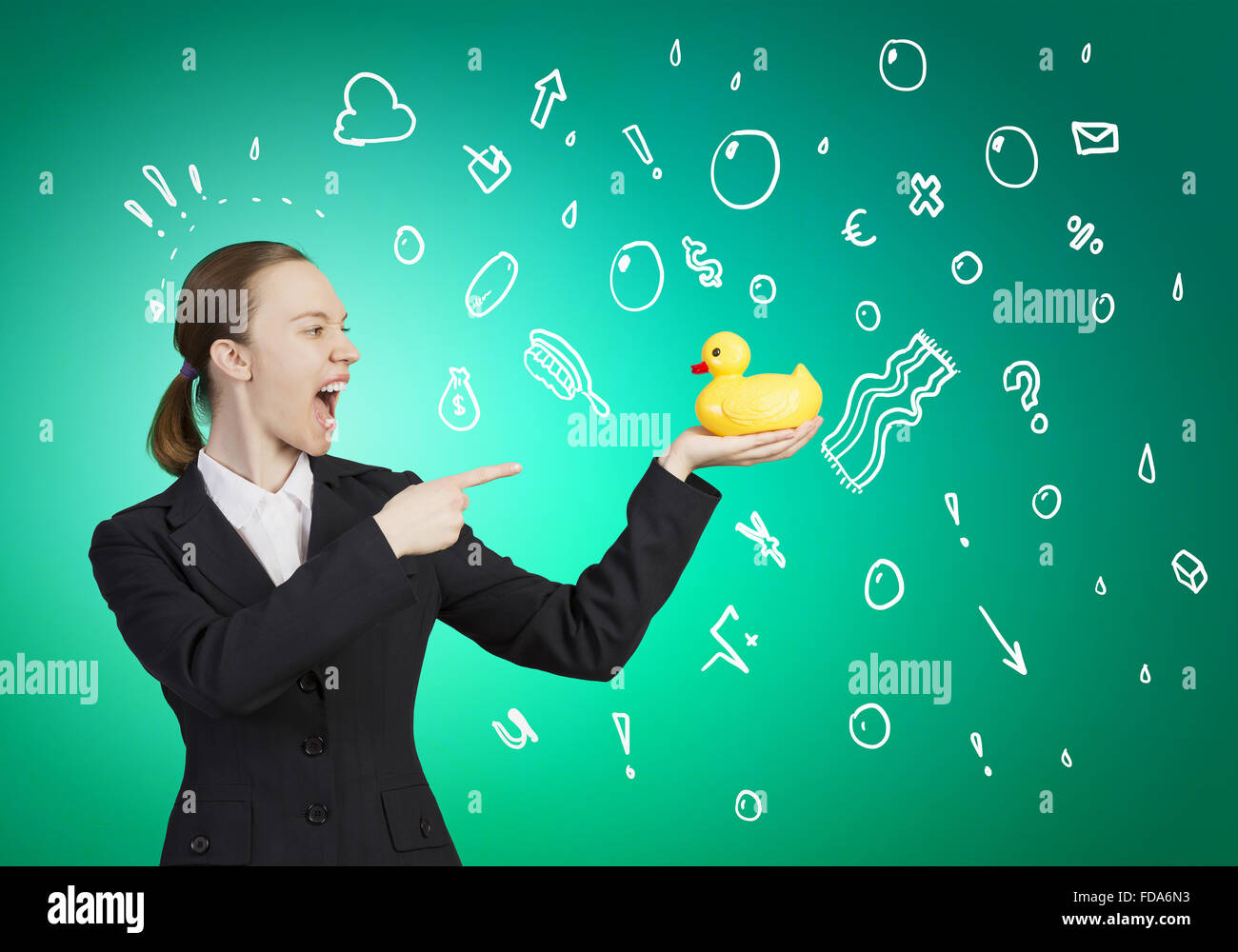 Young businesswoman screaming and pointing on yellow rubber duck toy ...