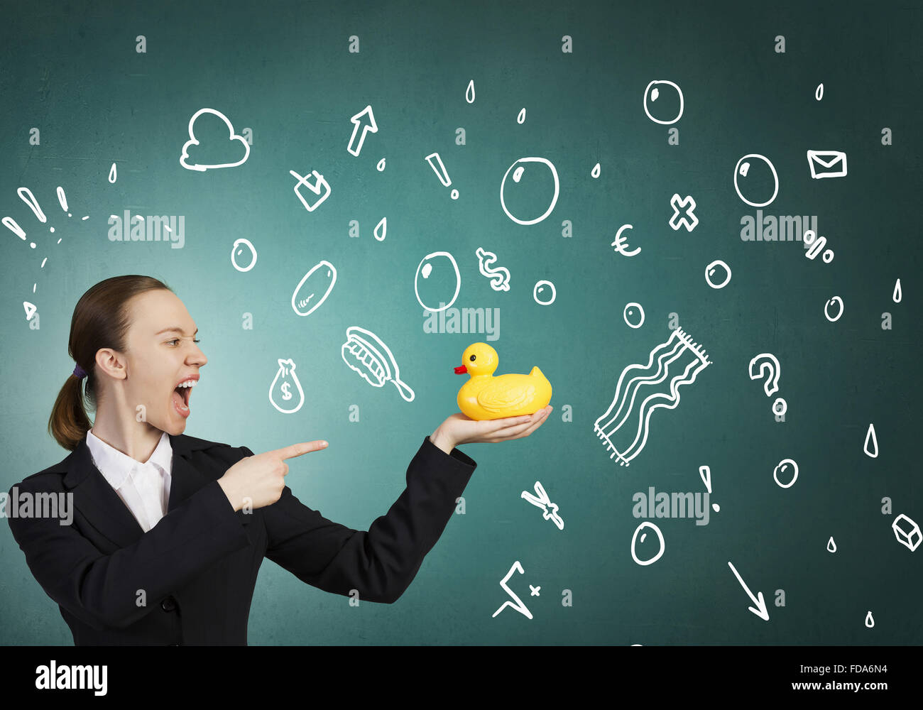 Young businesswoman screaming and pointing on yellow rubber duck toy ...